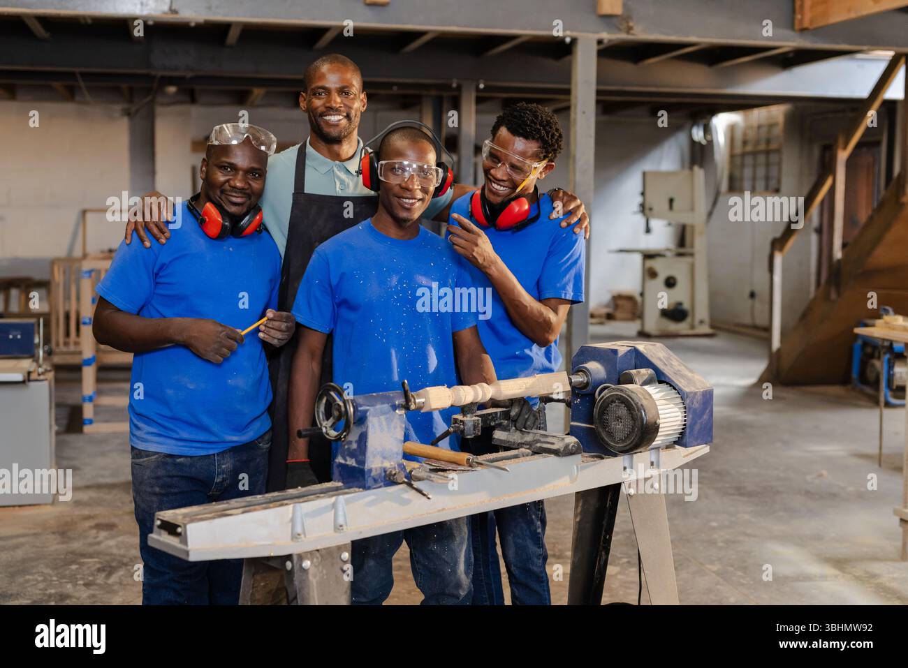 African American men working around wood lathe with chisels wearing ...