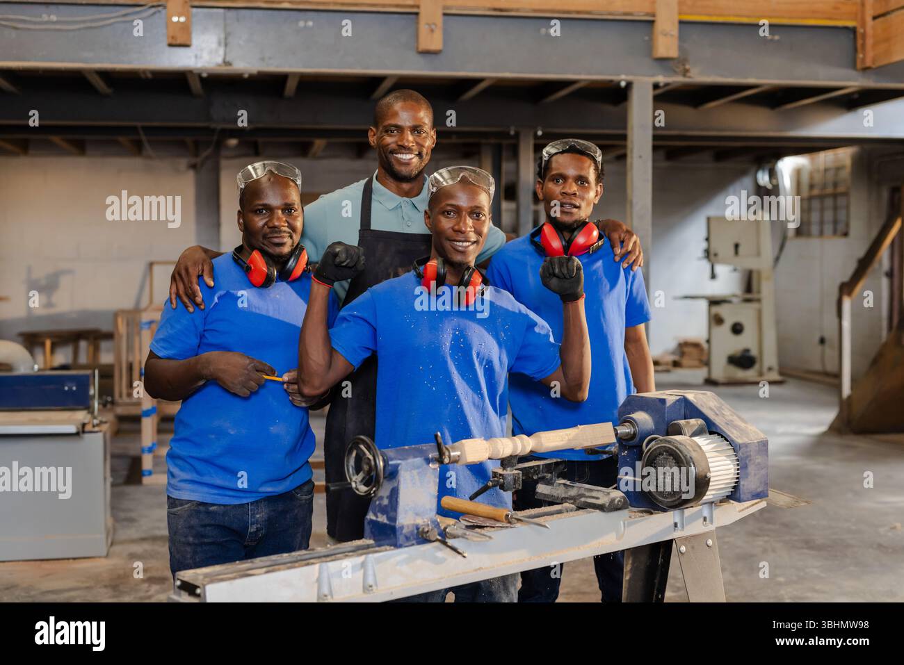 African American men posing behind wood lathe in workshop, wearing ...