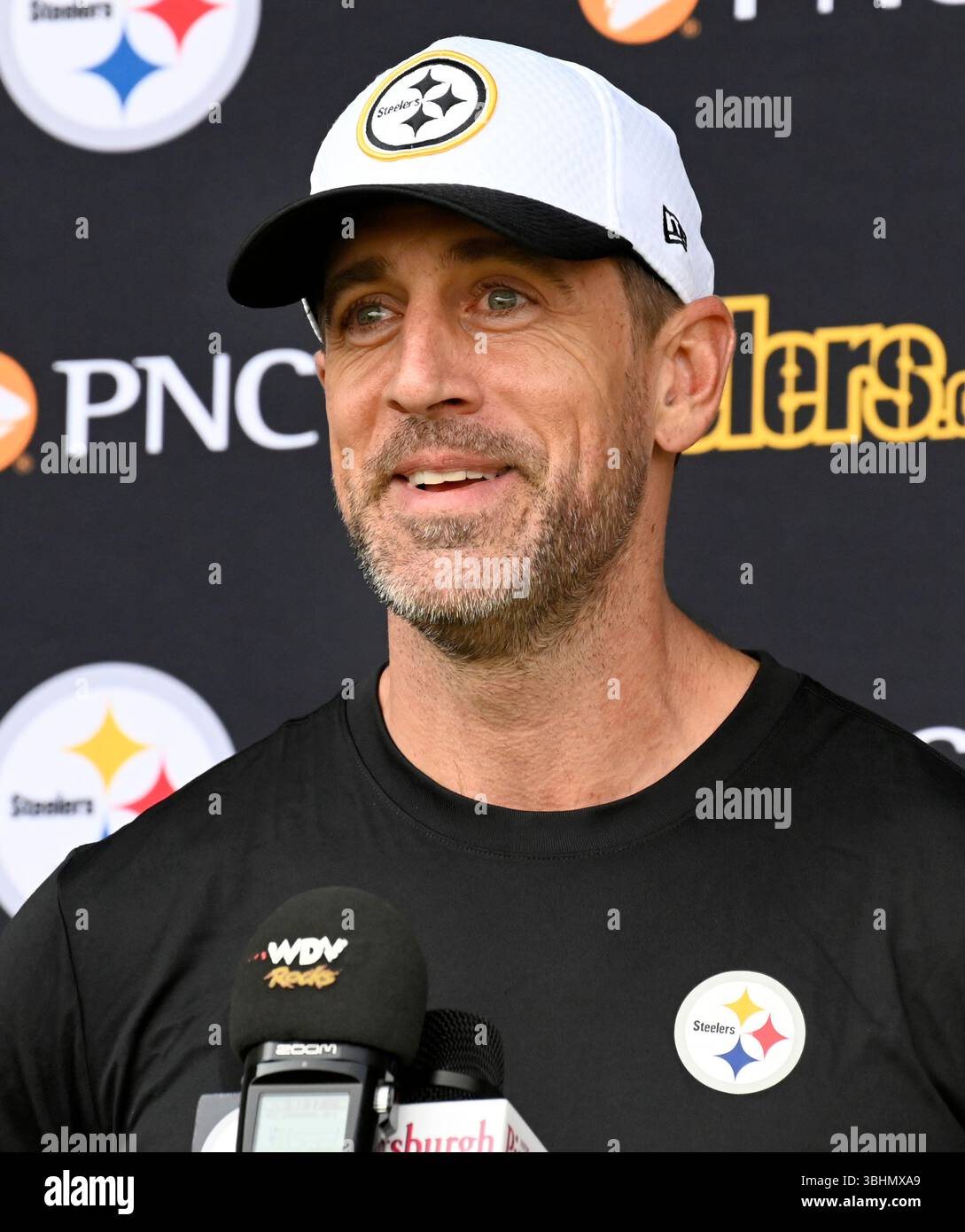 Newly-signed quarterback Aaron Rodgers talks with the media after the ...