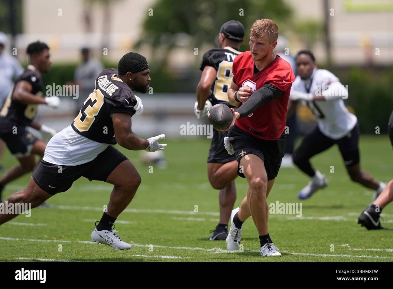 New Orleans Saints quarterback Tyler Shough hands off to New Orleans ...