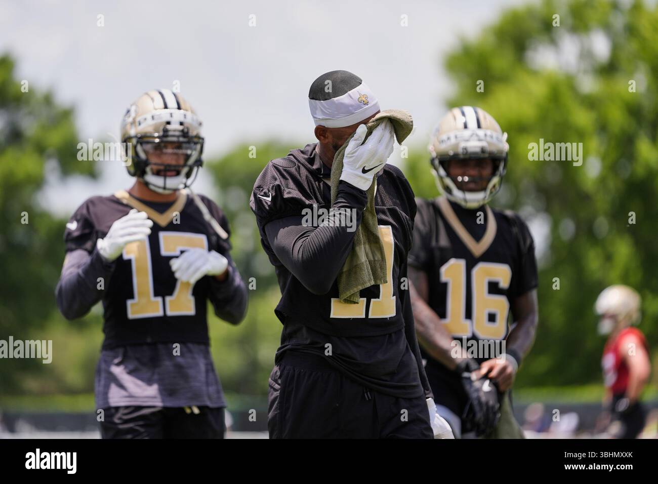 New Orleans Saints wide receiver Cedrick Wilson Jr. (11) wipes his face ...