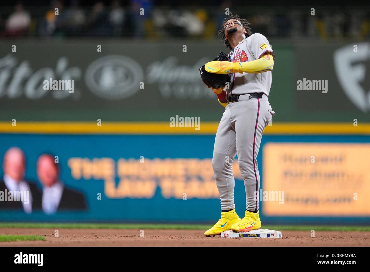 Atlanta Braves' Ronald Acuña Jr. swats at bugs during a baseball game ...