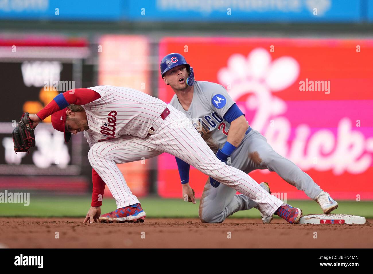Chicago Cubs' Nico Hoerner, right, reacts after being forced out at second by Philadelphia ...