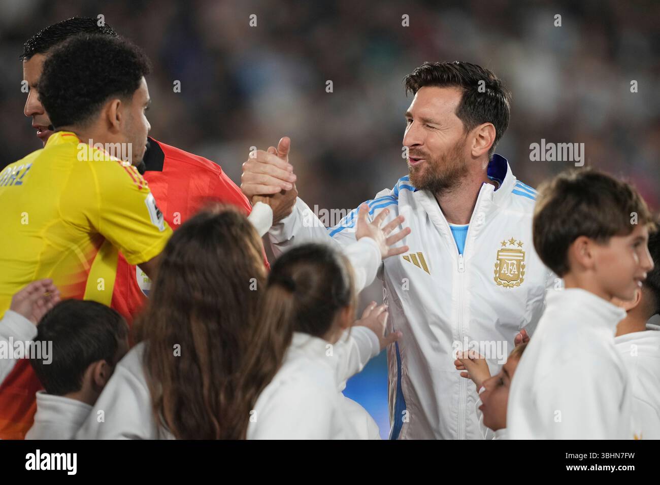 Argentina's Lionel Messi, right, and Colombia's Luis Diaz shake hands ...