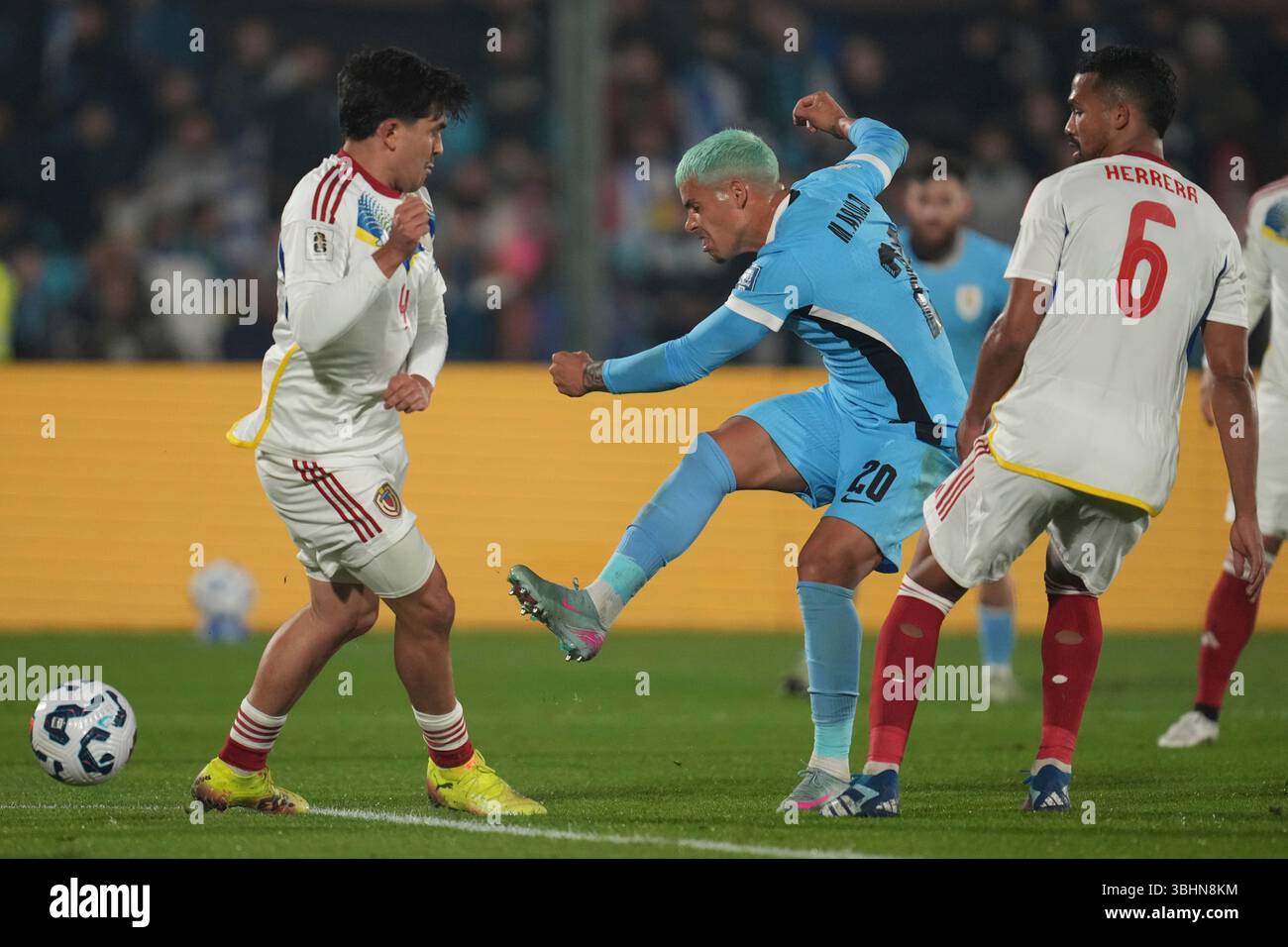 Uruguay's Maximiliano Araujo, center, shoots as Venezuela's Jon ...