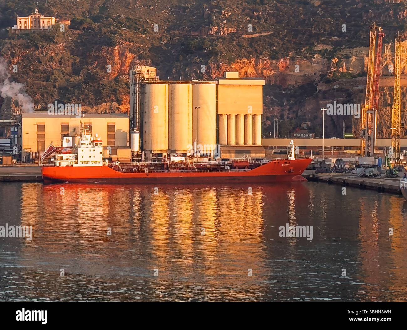 Barcelona, Spain - July 11, 2024: Sunrise over Bunge Iberica tanks and ...