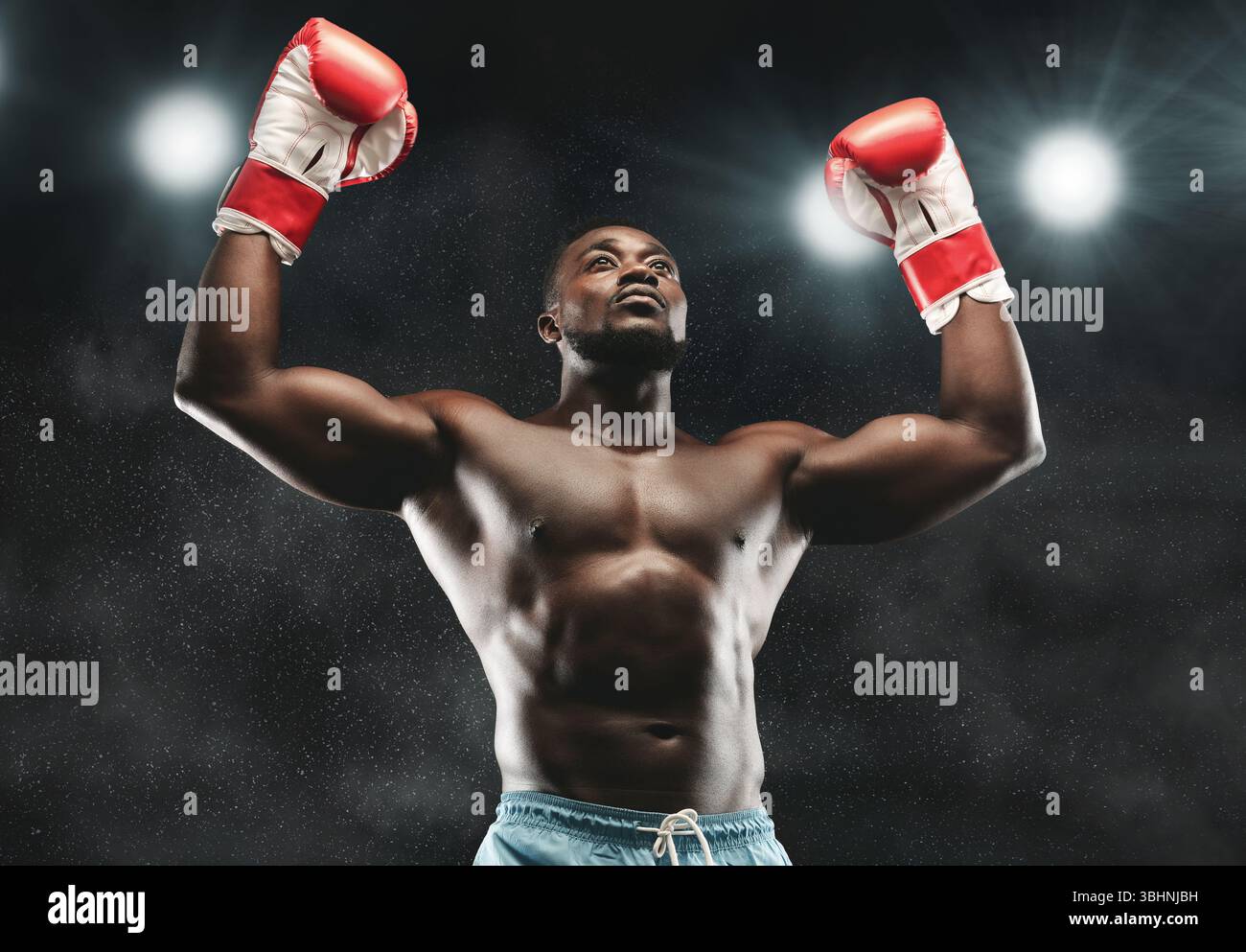 African boxer raising his arms in winner gesture Stock Photo - Alamy