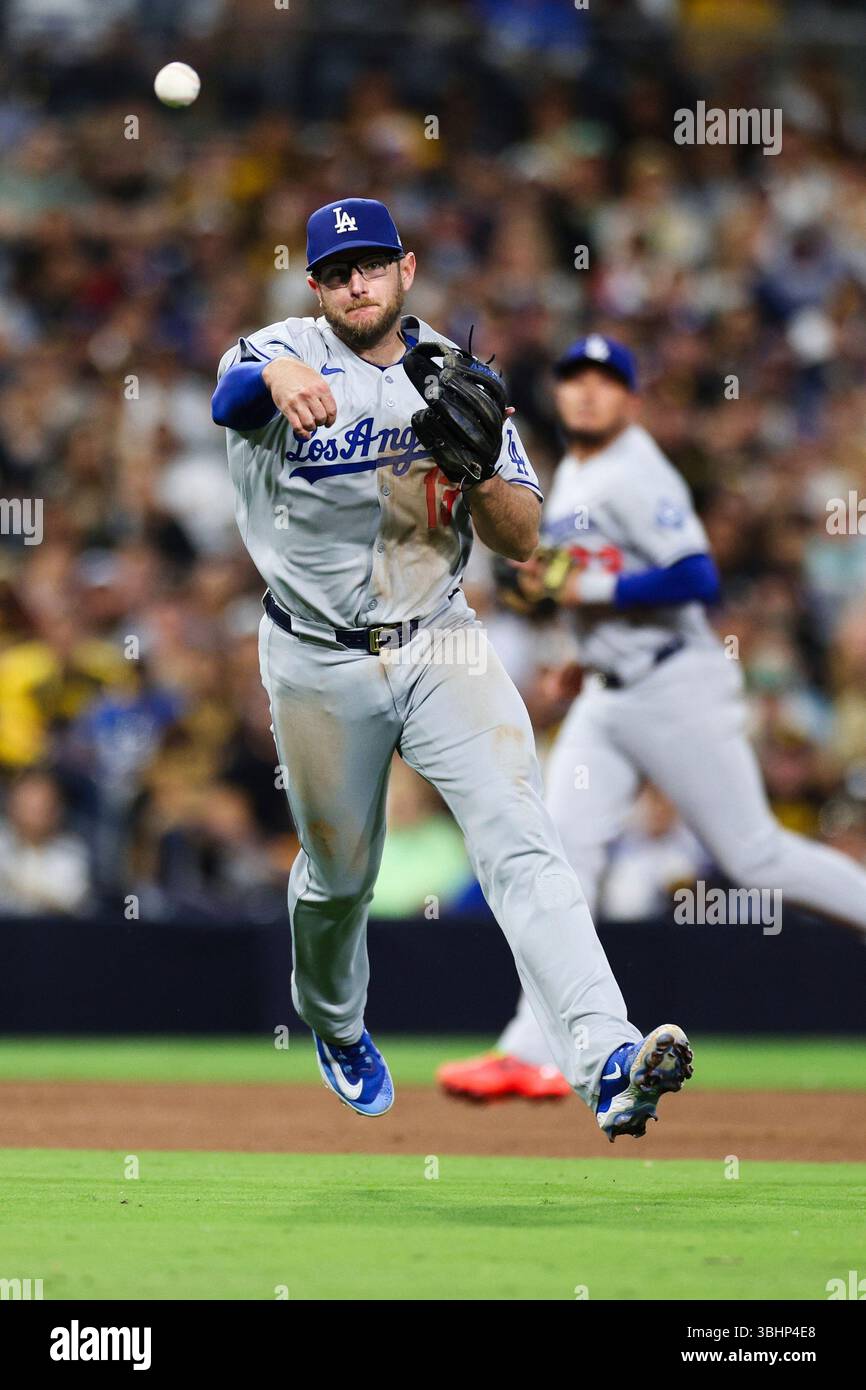 Los Angeles Dodgers' Max Muncy throws San Diego Padres' Manny Machado ...
