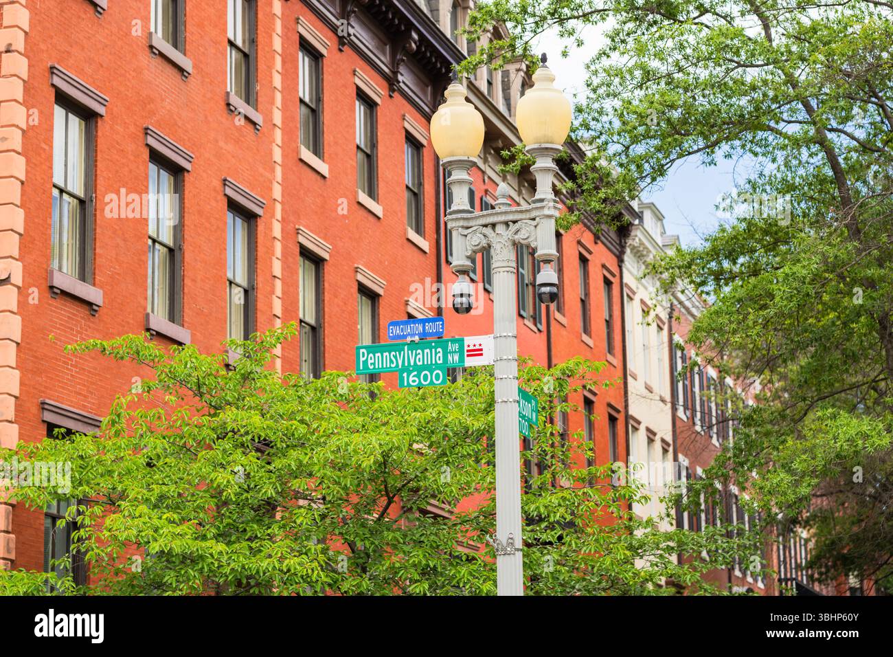 Red brick facades and lush green trees line Pennsylvania Avenue in a ...