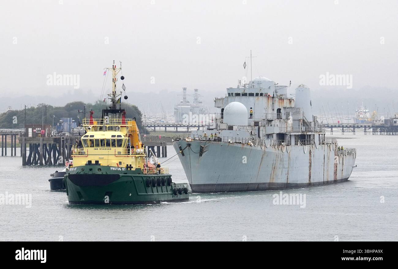 The former Royal Navy Type 82 Destroyer HMS Bristol is towed out of Portsmouth harbour ...
