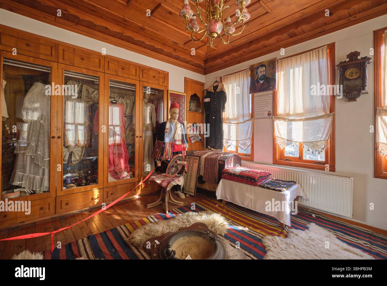 A room crammed with various wardrobe, clothes, including a mannequin ...