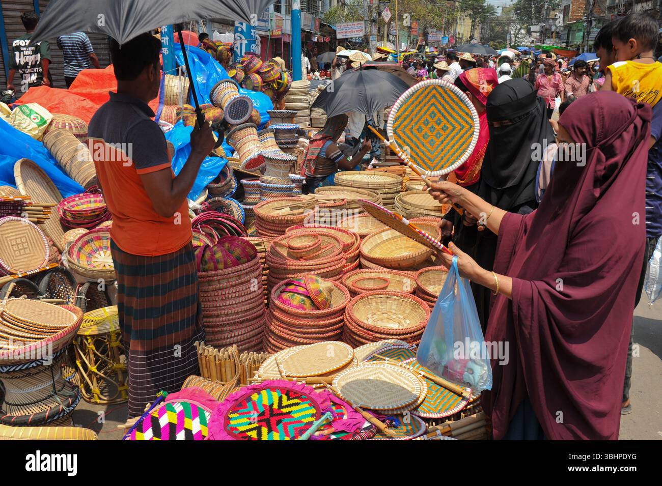 A Women is buying cane products at the Boishakhi Fair in Laldighi ...