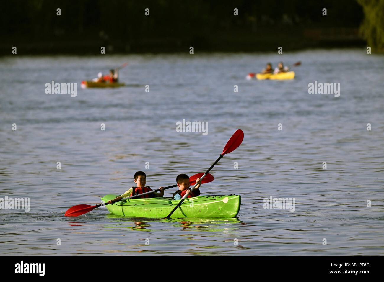 Tourists experience kayaking on the river in Shenyang City, northeast ...