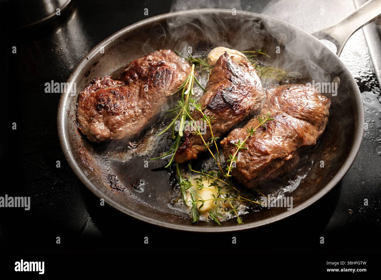 Beef steak steaming cooking in hi-res stock photography and images - Alamy