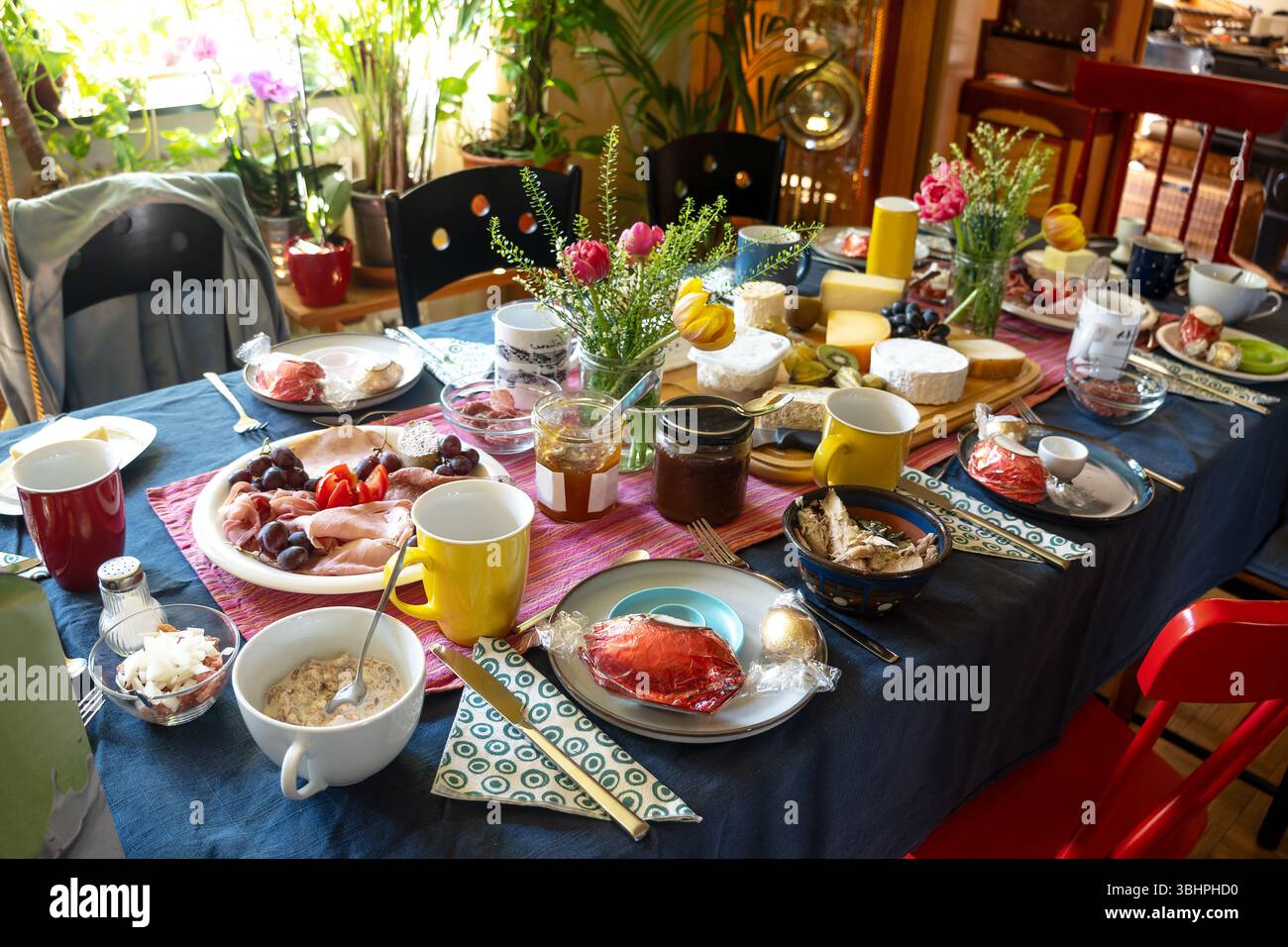Large dining table, opulent and colorful setting with a lot of food ...