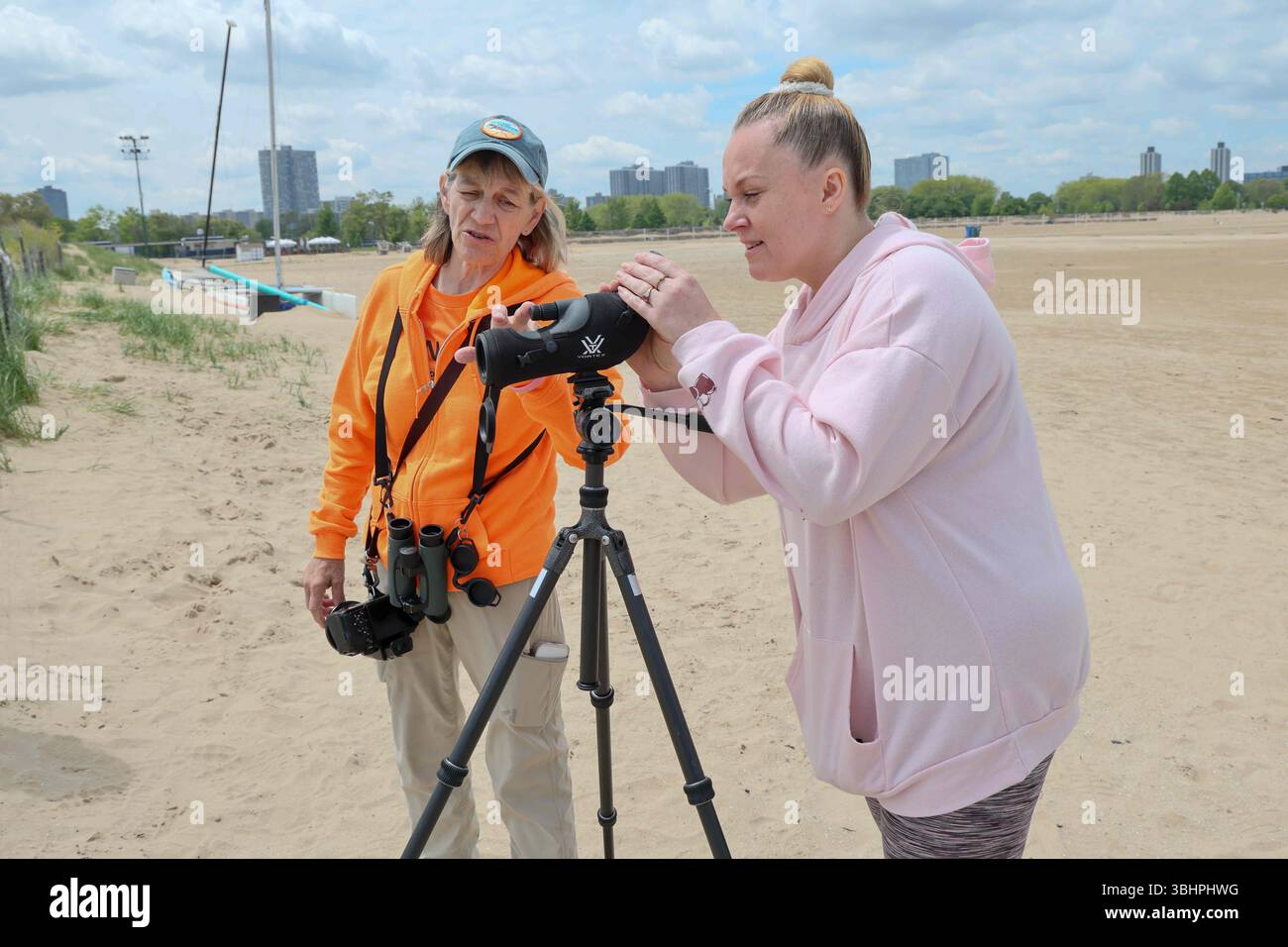 Volunteer Lynn from the Chicago Piping Plovers shows an onlooker the ...
