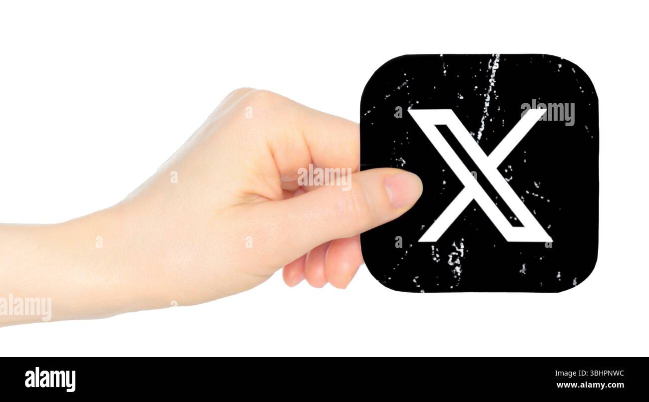 Hand holds paper X - Twitter mobile app icon, on a transparent ...