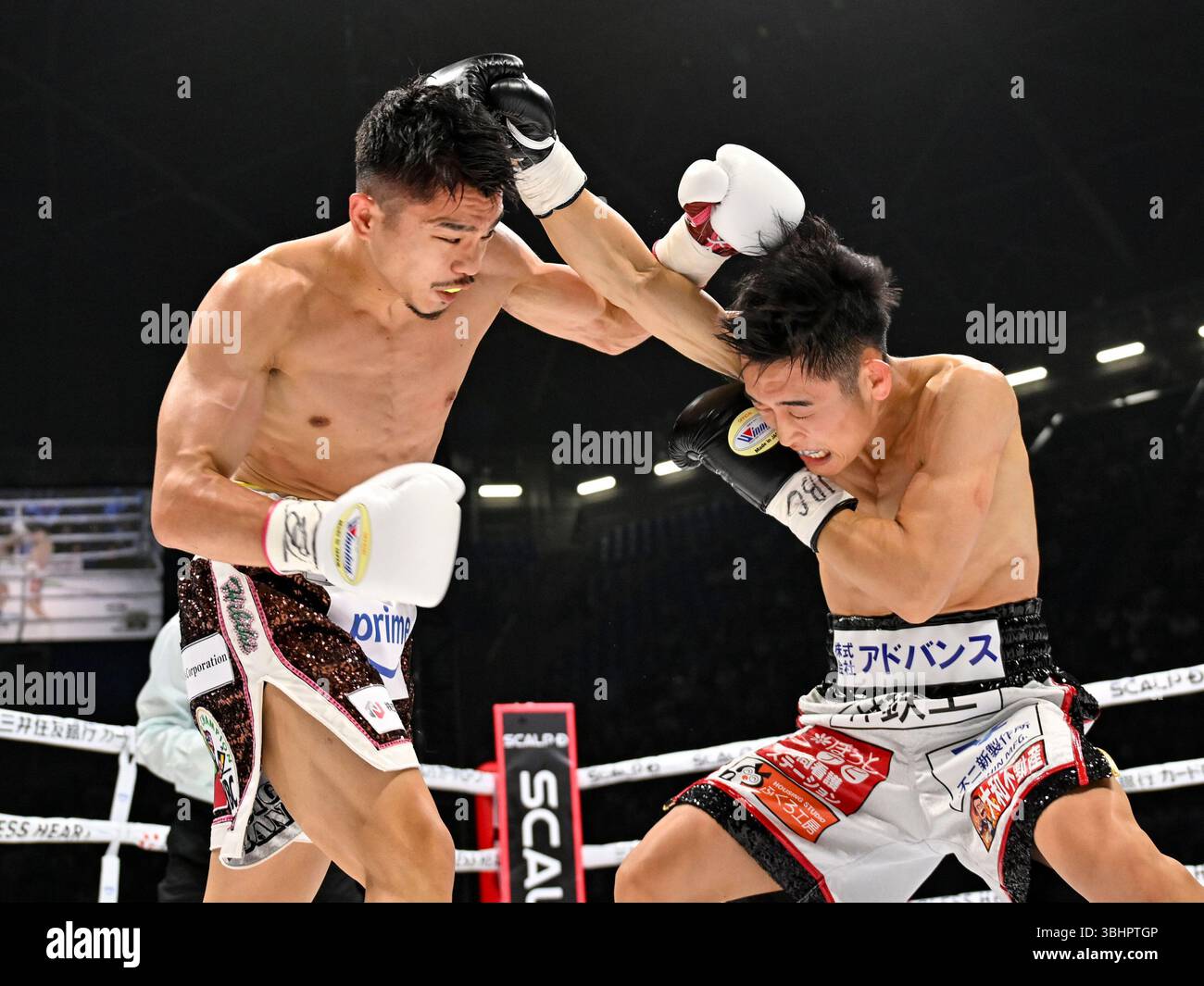 Junto Nakatani (white gloves) and Ryosuke Nishida (black globes) compete during their WBC and ...