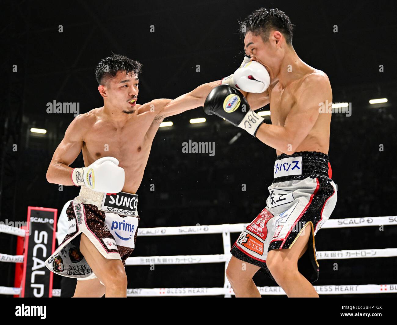 Junto Nakatani (white gloves) and Ryosuke Nishida (black globes) compete during their WBC and ...