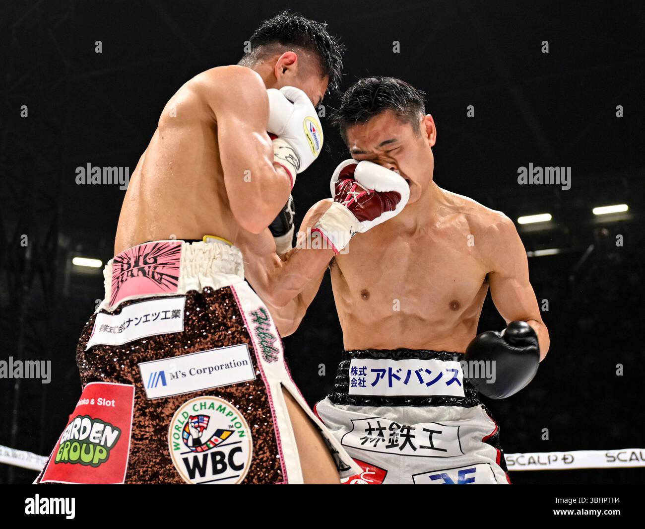 Junto Nakatani (white gloves) and Ryosuke Nishida (black globes) compete during their WBC and ...