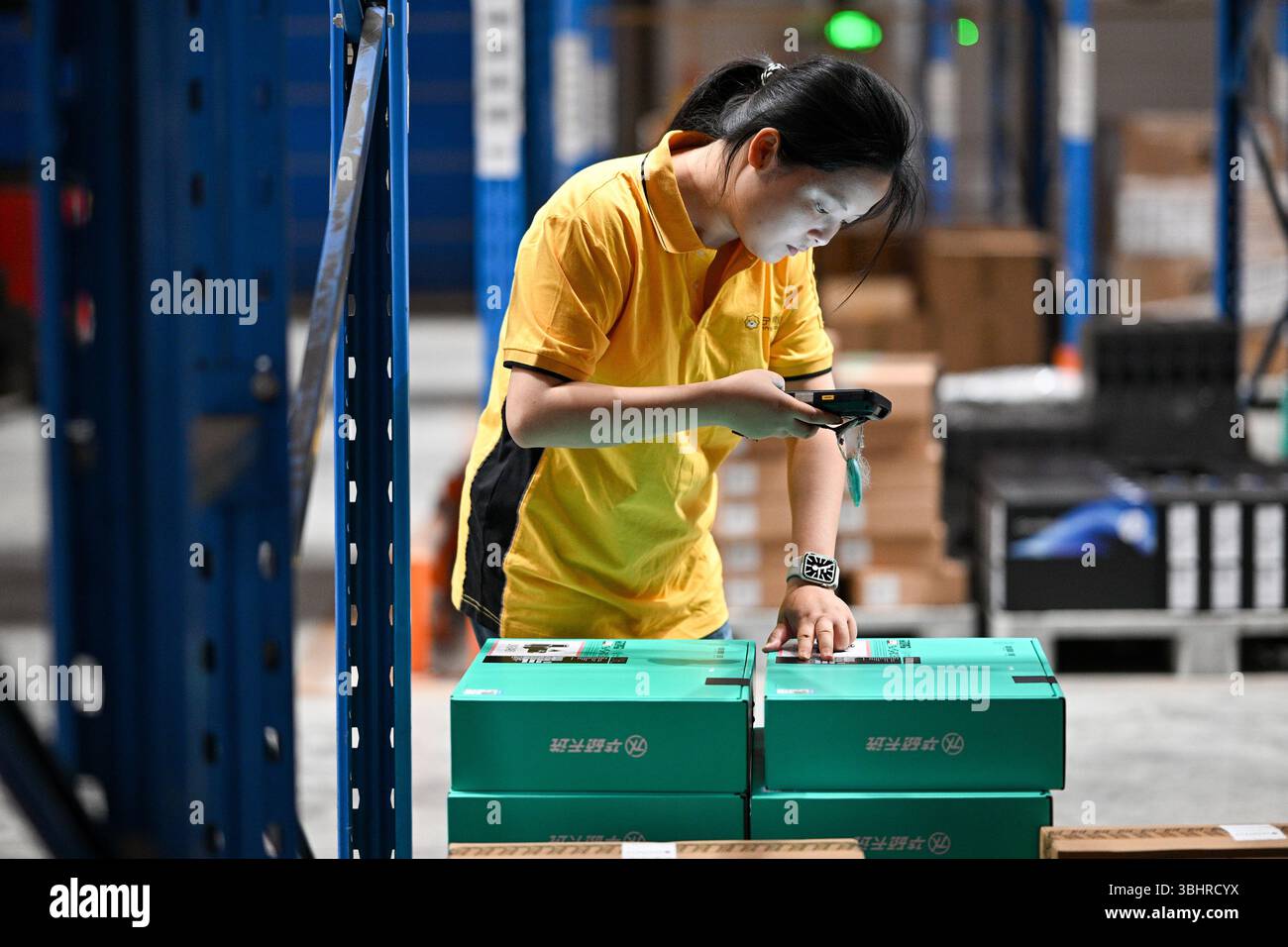 NANJING, CHINA - JUNE 11, 2025 - A worker is picking goods at Suning's ...