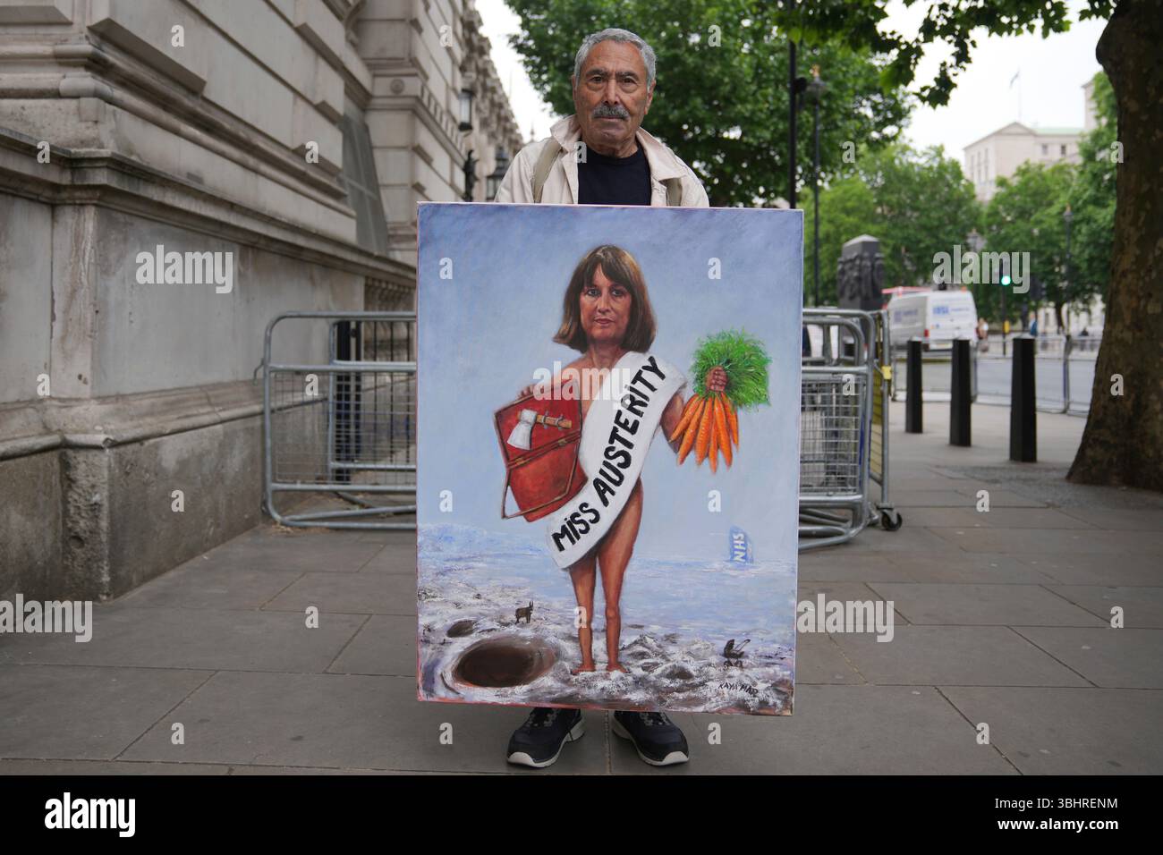 Political artist Kaya Mar poses with his artwork depicting British ...