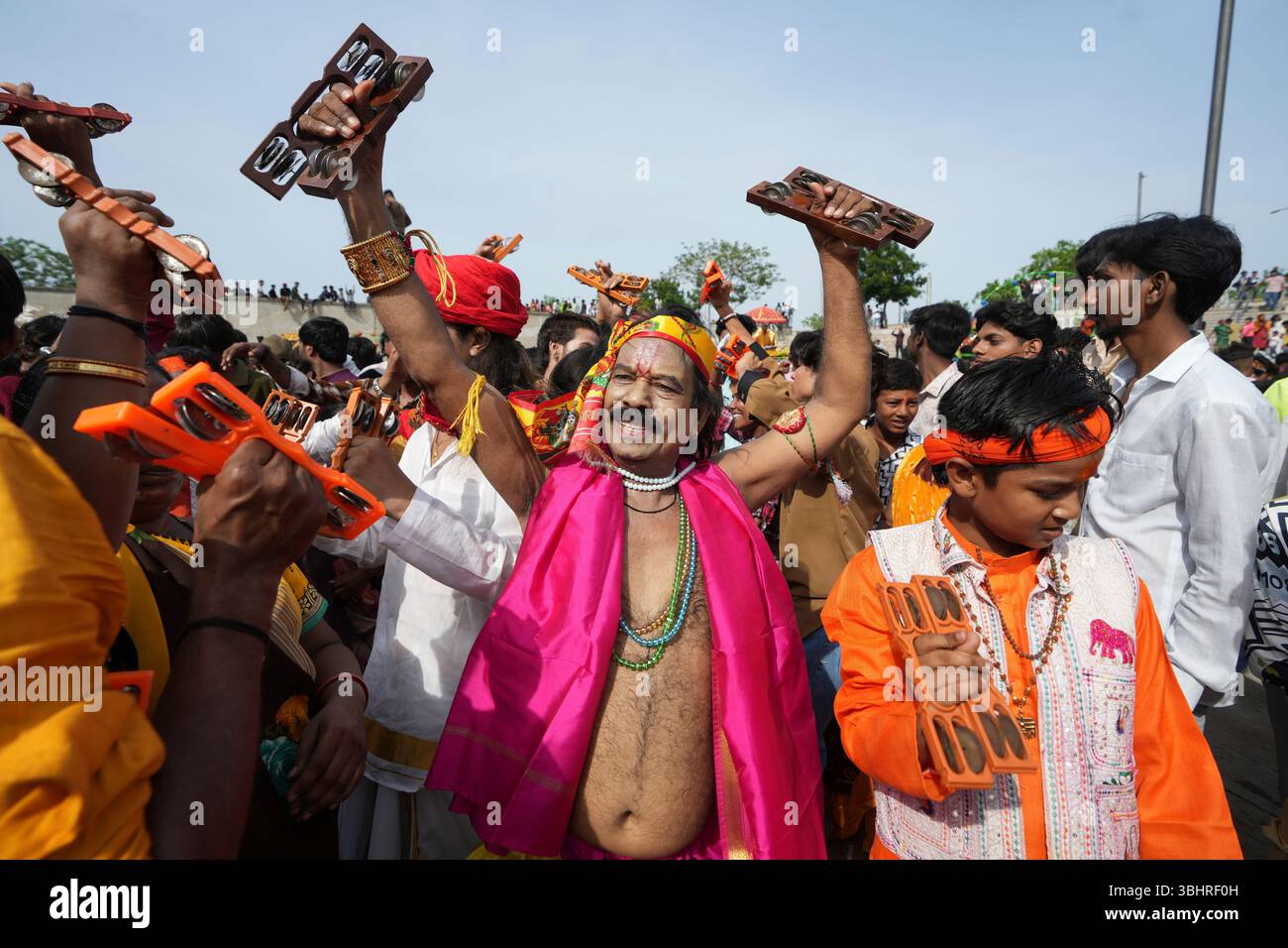Devotees dance during a religious procession called Jal Yatra, ahead of ...