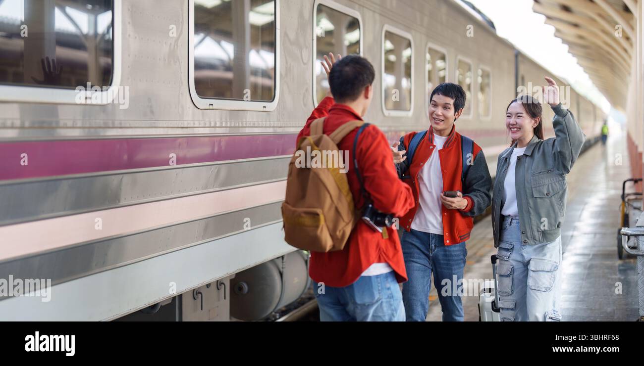 Farewell Wave. Friends saying goodbye at the train station Stock Photo - Alamy