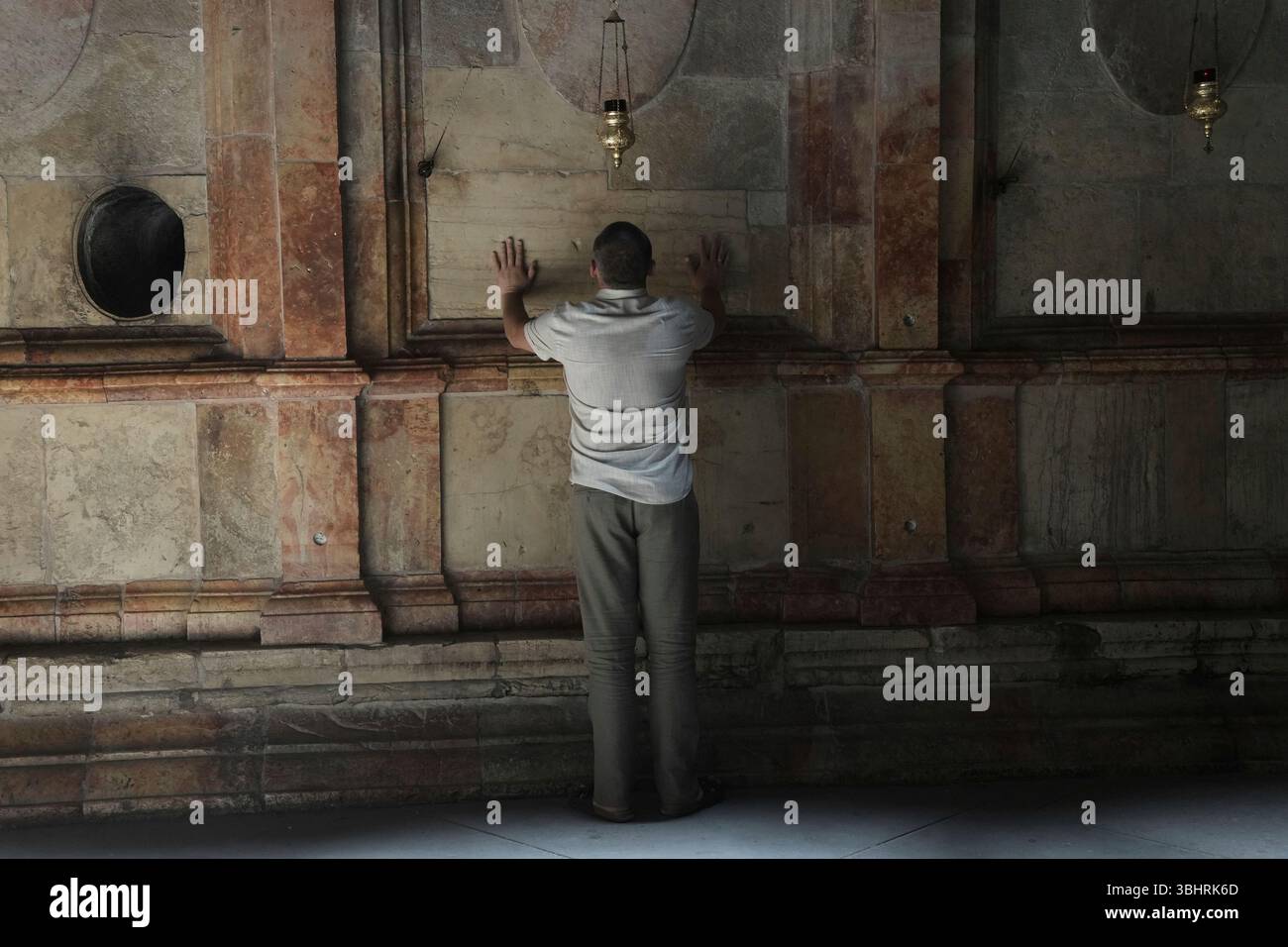 A man visits the Church of the Holy Sepulcher, the site where according ...