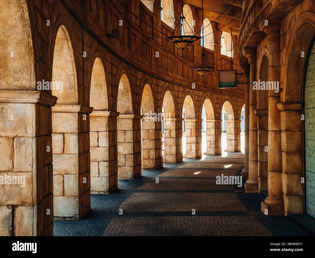 Sunlit Stone Archway In Macau: Elegant Curved Colonnade With Repeating ...