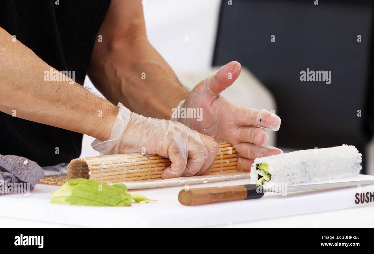 Human hands cooking sushi rolls hi-res stock photography and images - Alamy