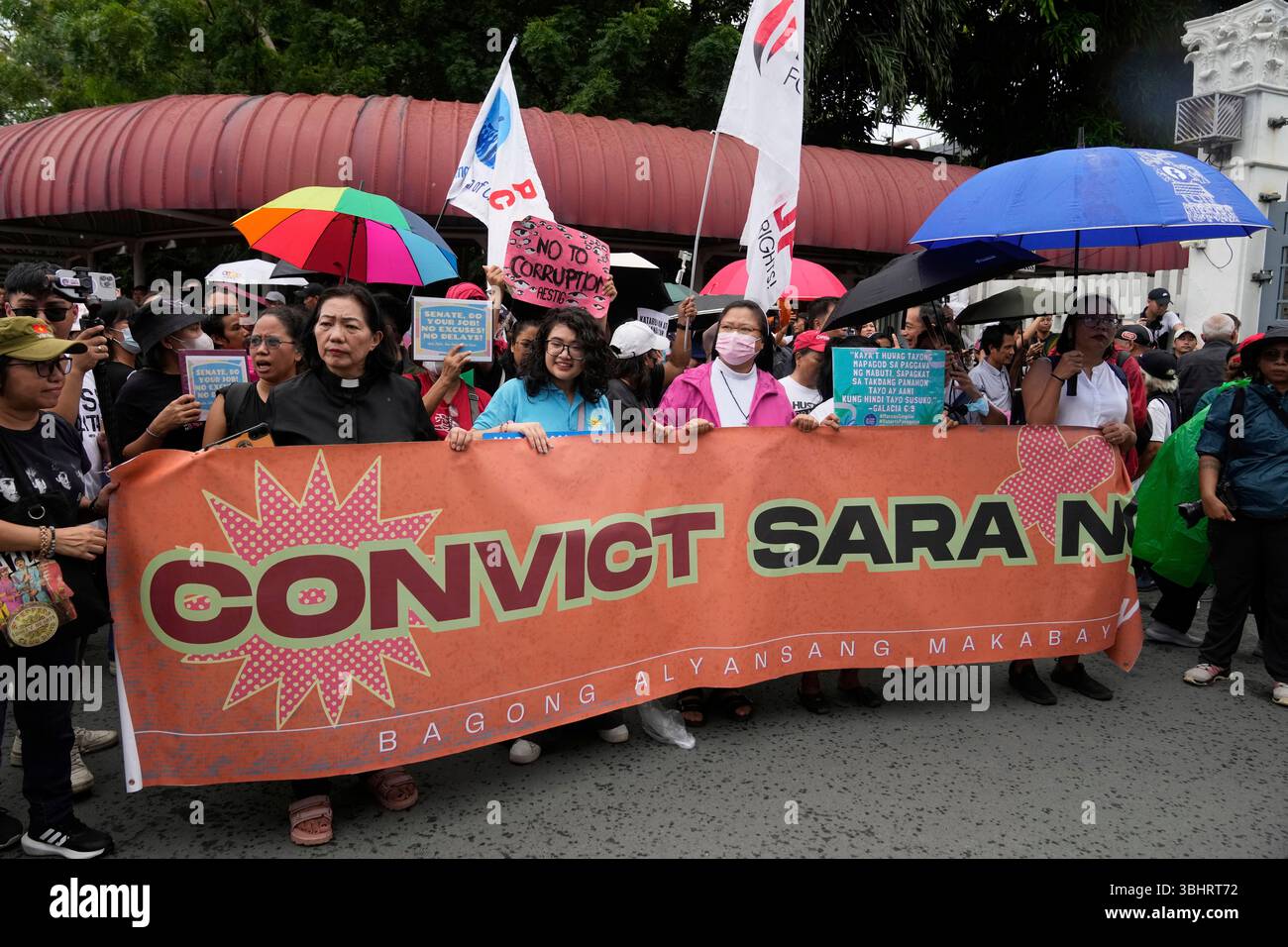 Protesters hold slogans during a rally to condemn the senate's recent ...