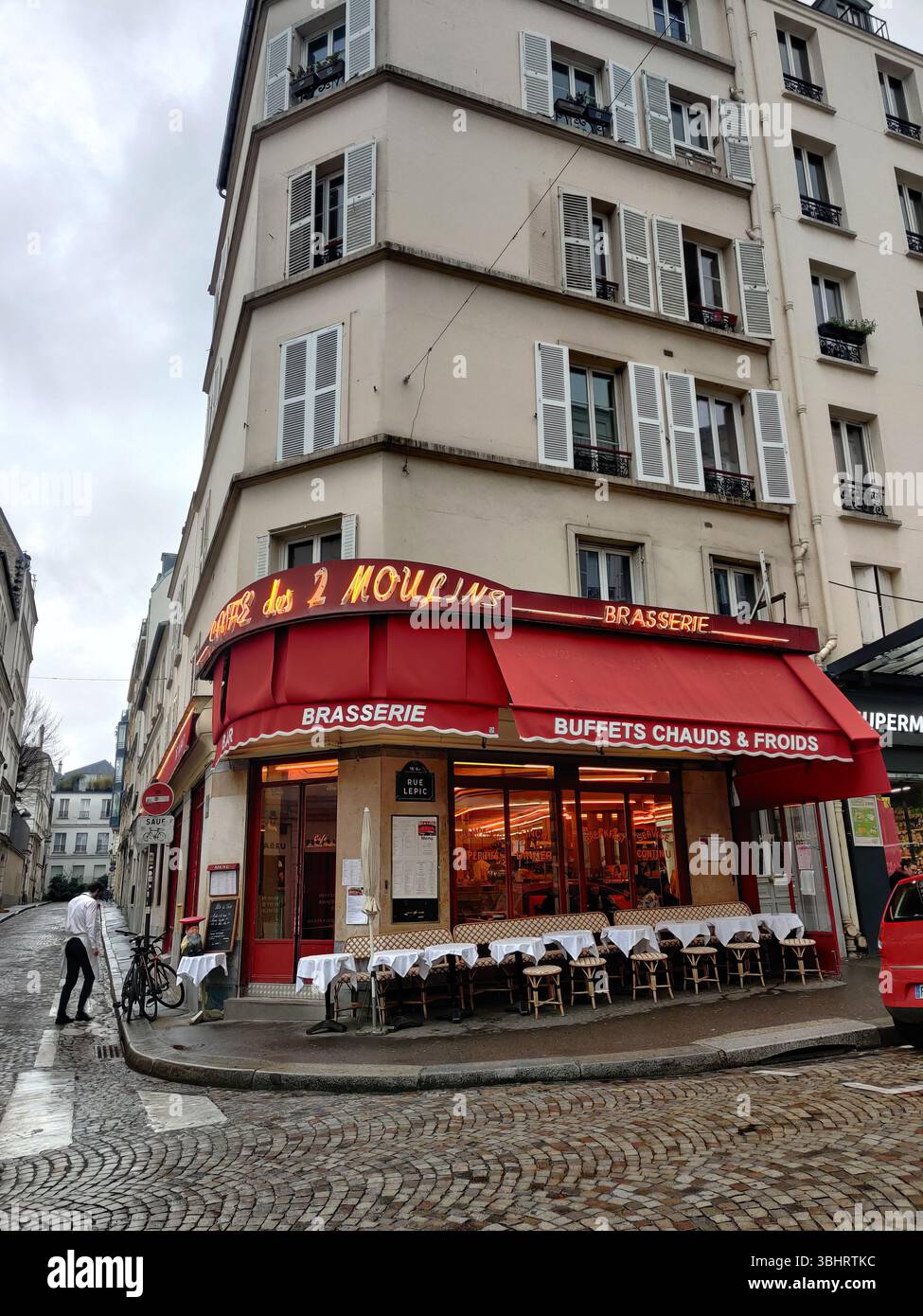 Paris, France - February 28, 2025: Les Deux Moulins cafe in Montmartre ...