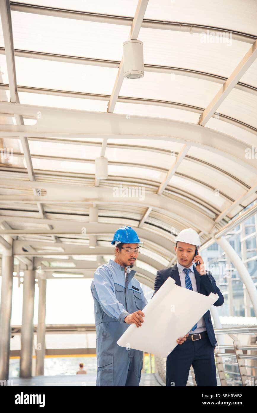 Civil engineer teams meeting working together wear worker helmets hardhat on construction site ...