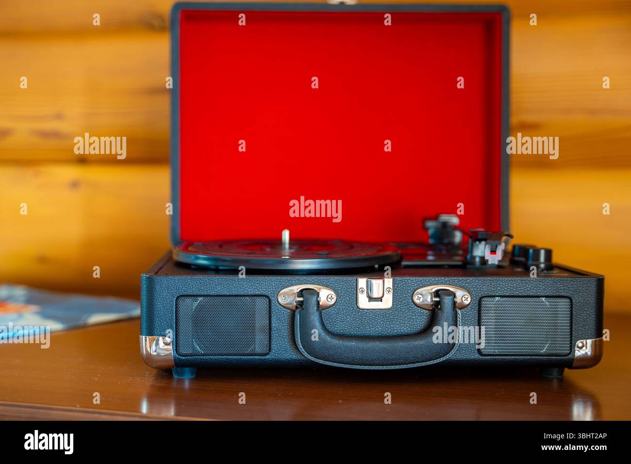 Open vintage record player in suitcase design with vinyl lying nearby ...