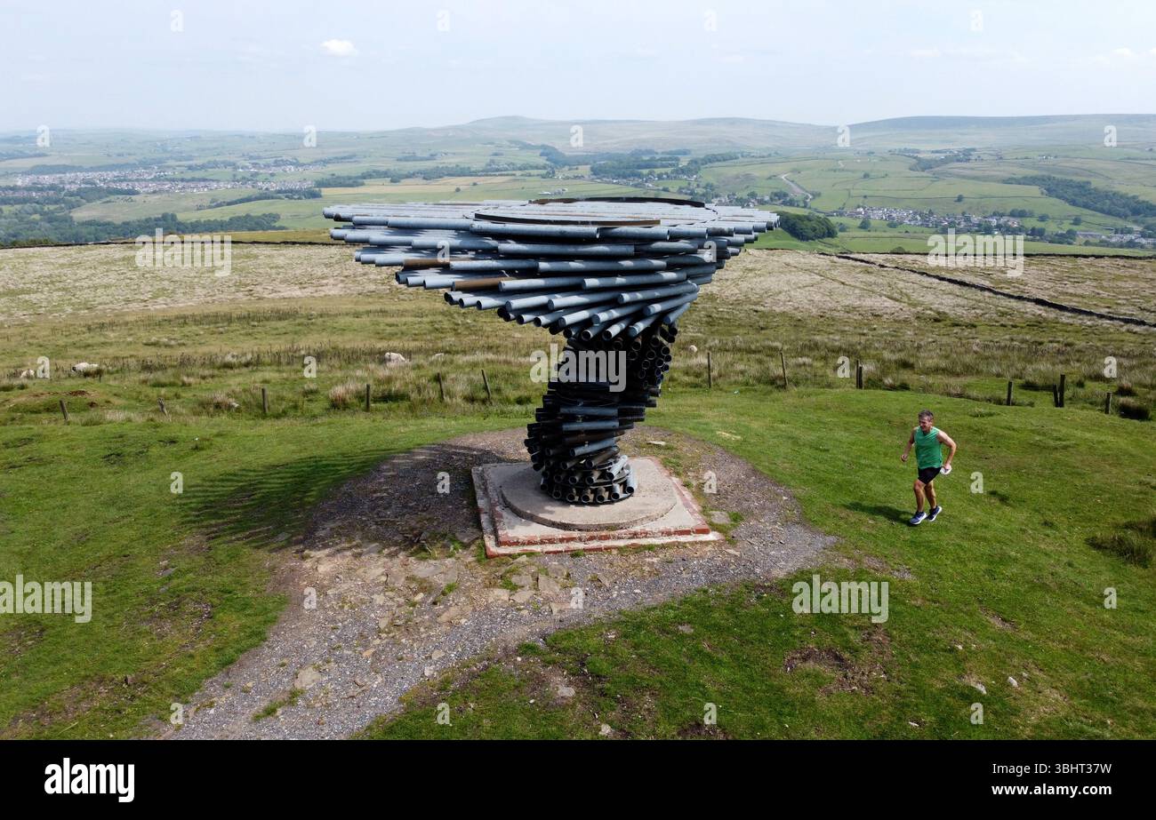 A runner passes the Singing Ringing Tree, a musical sculpture designed ...