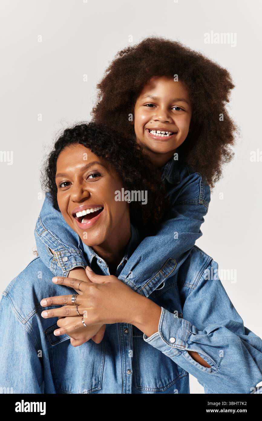 A happy African American Mother and daughter are laughing and hugging in studio Stock Photo - Alamy