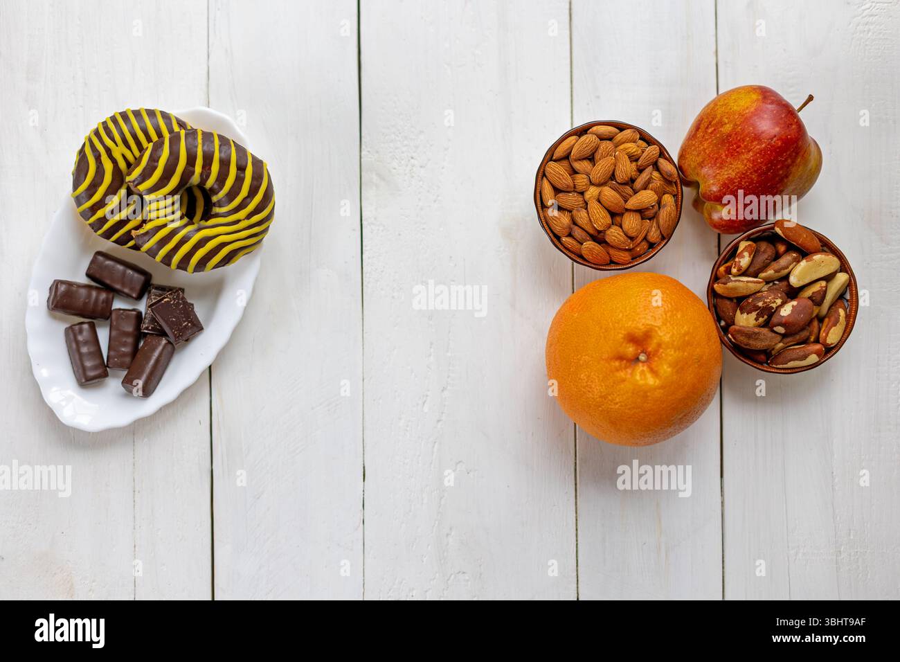 Healthy Snacks vs Sugary Treats on White Table. Top view of a ...