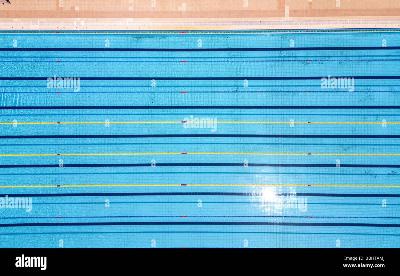Aerial top-down view of an Olympic-size swimming pool with marked lanes ...