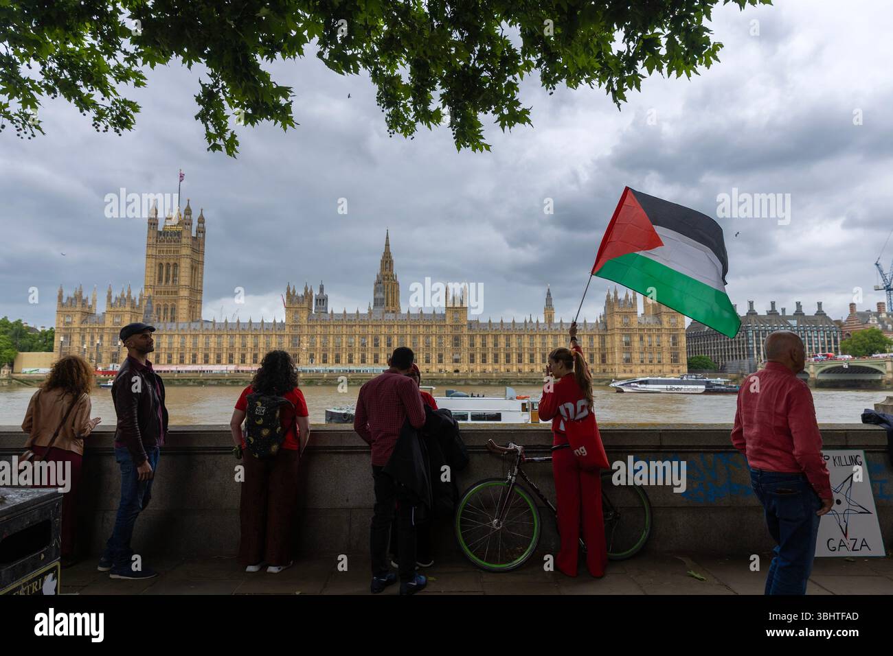 Pro-Palestinian protesters wearing red create a red line for Palestine ...
