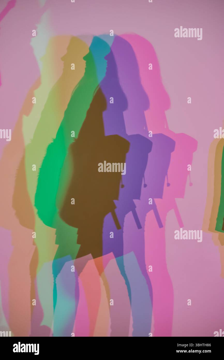 Colorful shadows cast on a wall through RGB lighting, creating an ...