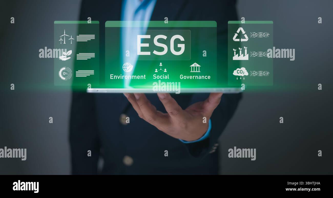 Hand holding tablet displaying holographic ESG interface with ...