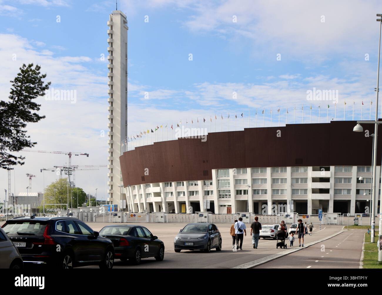 Parked cars on parking lot in front of Helsinki Olympic Stadium and the ...
