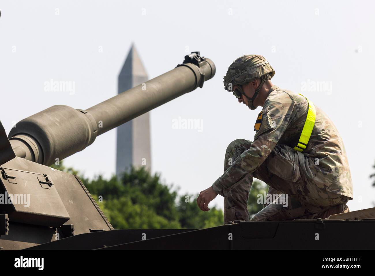 Washington, United States. 11th June, 2025. A US soldier sits atop an ...