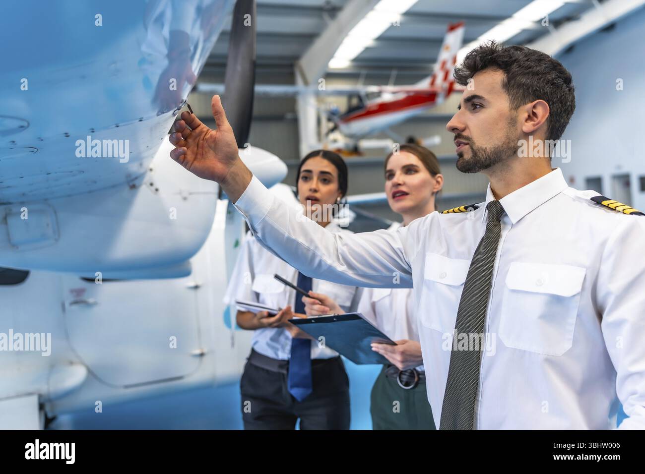 Maintenance team examining aircraft wing in hangar, ensuring flight ...