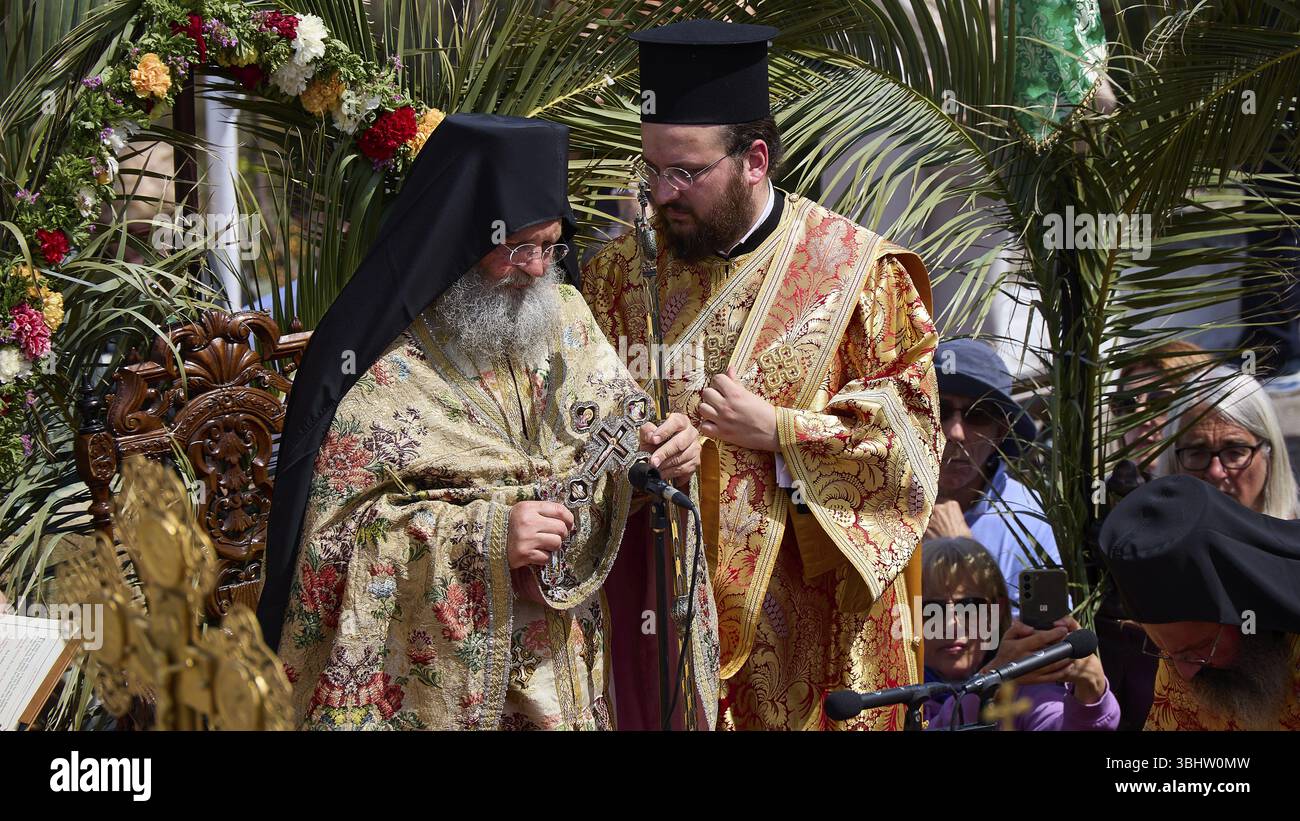 Two priests in rich robes stand in the middle of a solemn ceremony with ...