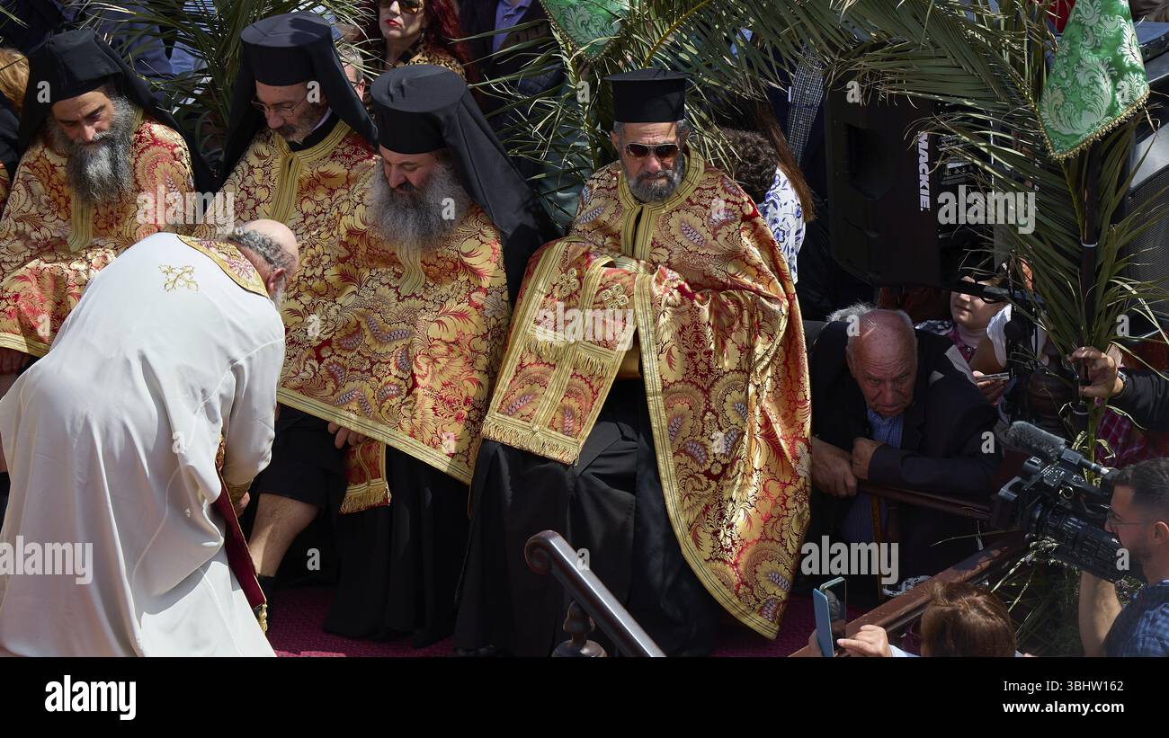 Priests in golden robes perform a religious ritual in front of a ...