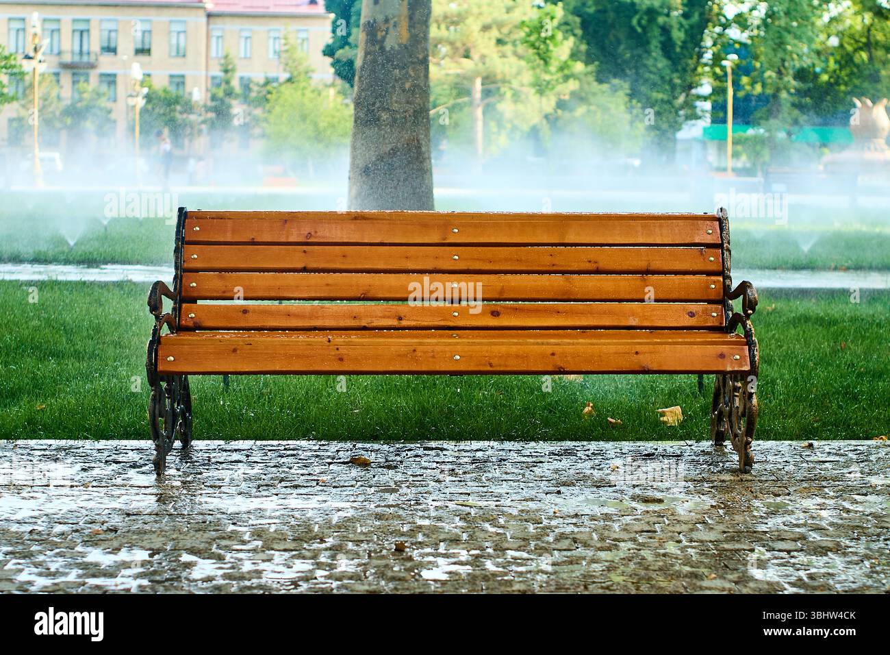 Sprinkler operating in rain watering hi-res stock photography and ...