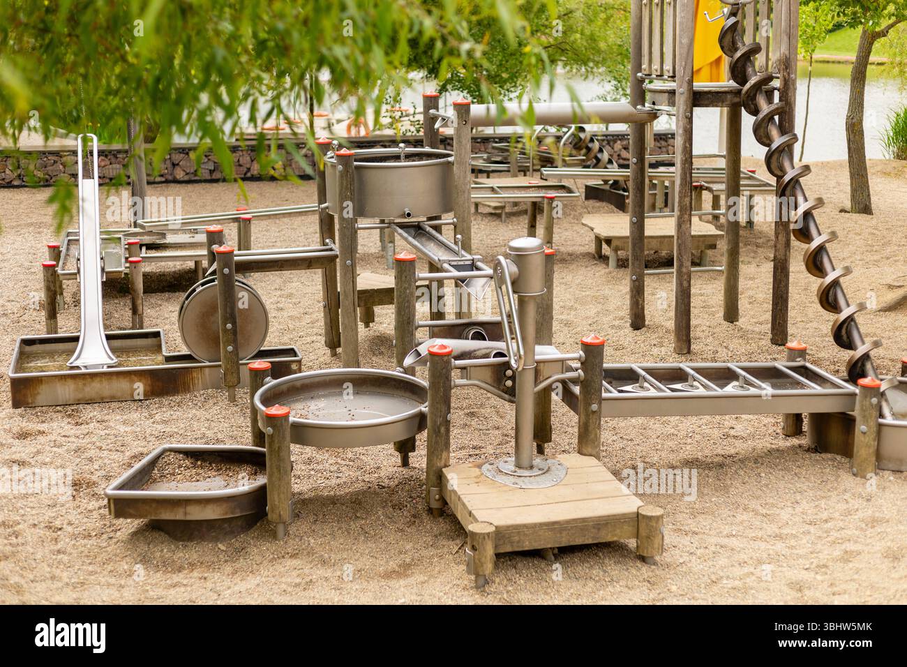 This engaging water play structure features various channels, slides ...