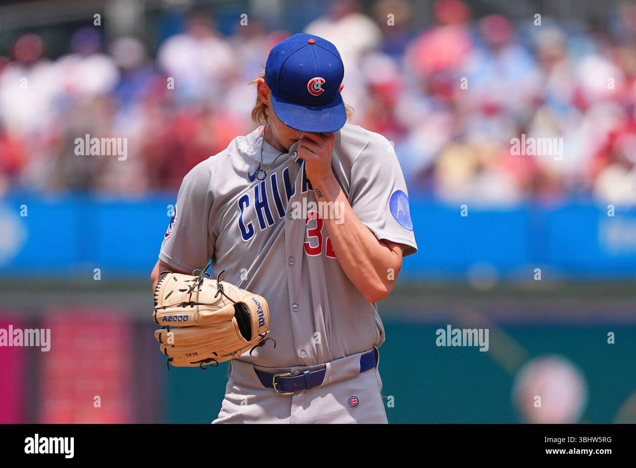 Chicago Cubs pitcher Ben Brown wipes his face after giving up a run ...